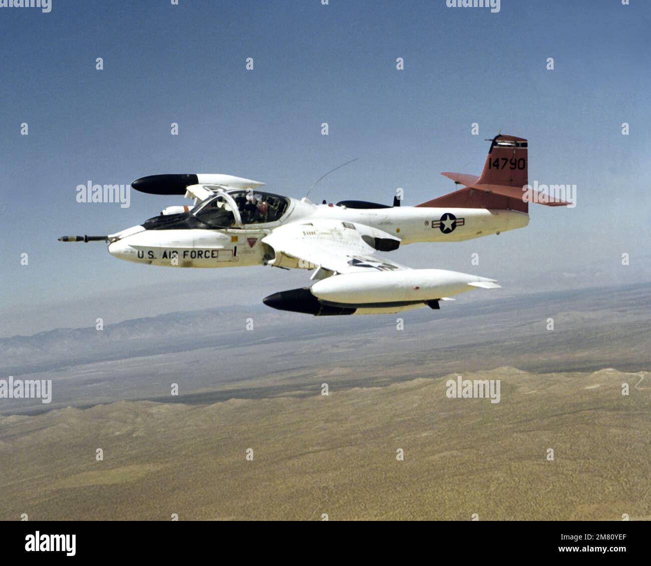 An air-to-air left side view of an OA-37 Dragonfly aircraft with a Mark ...