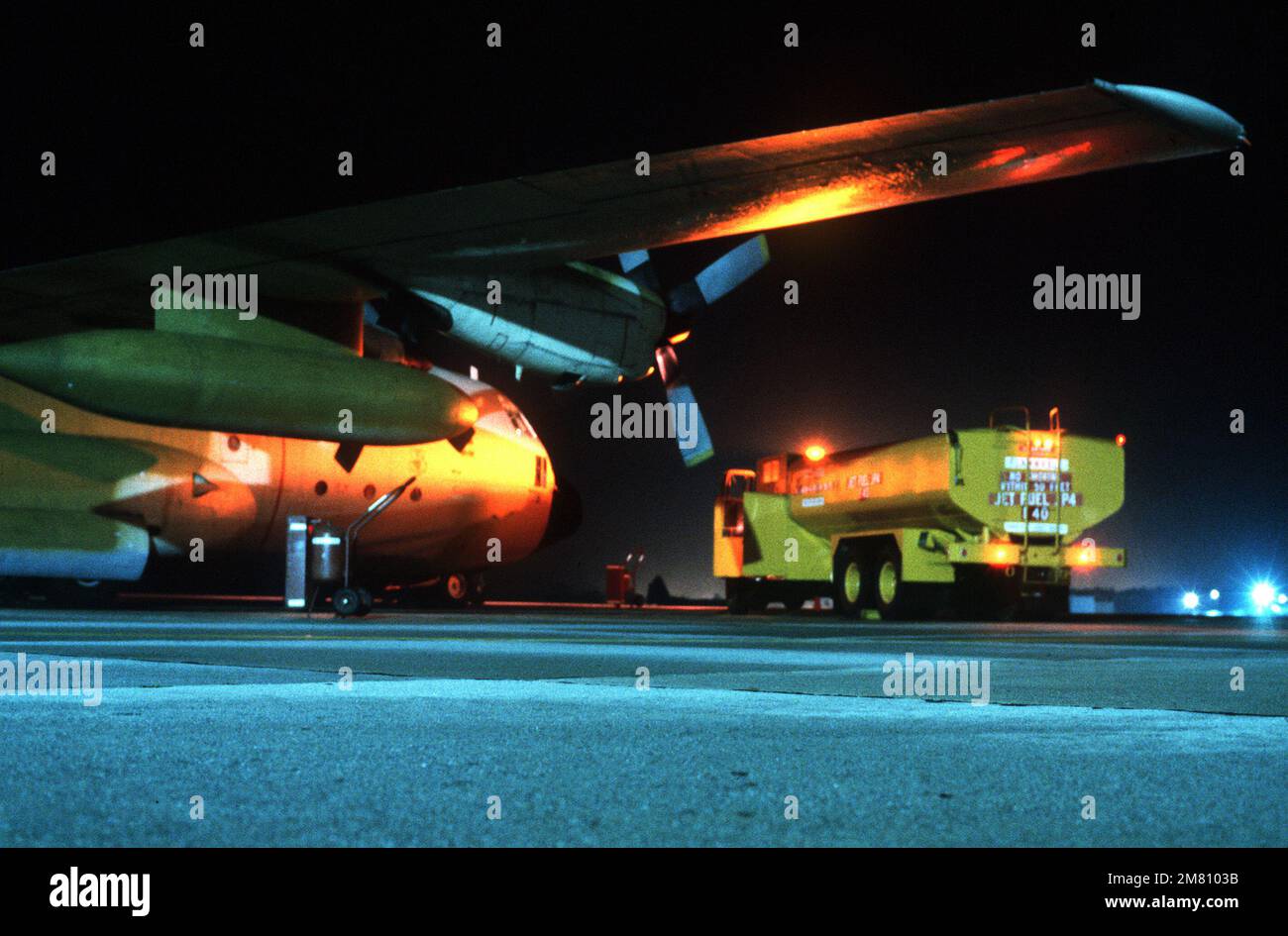A C-130 Hercules aircraft is refueled at night during the 314th ...