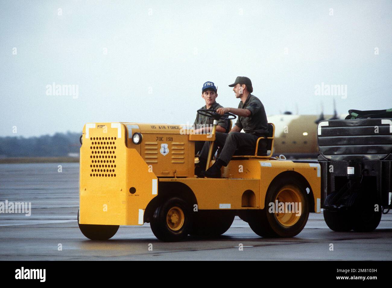 Members of the 314th Field Maintenance Squadron move supplies to the ...