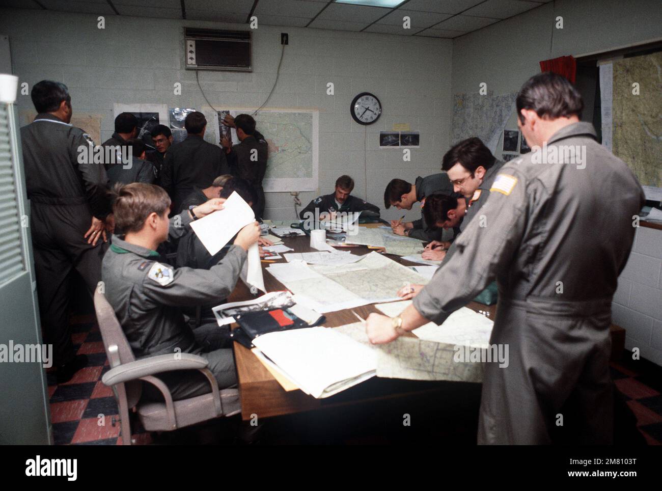 Members of the 61st Tactical Airlift Squadron prepare to file flight ...