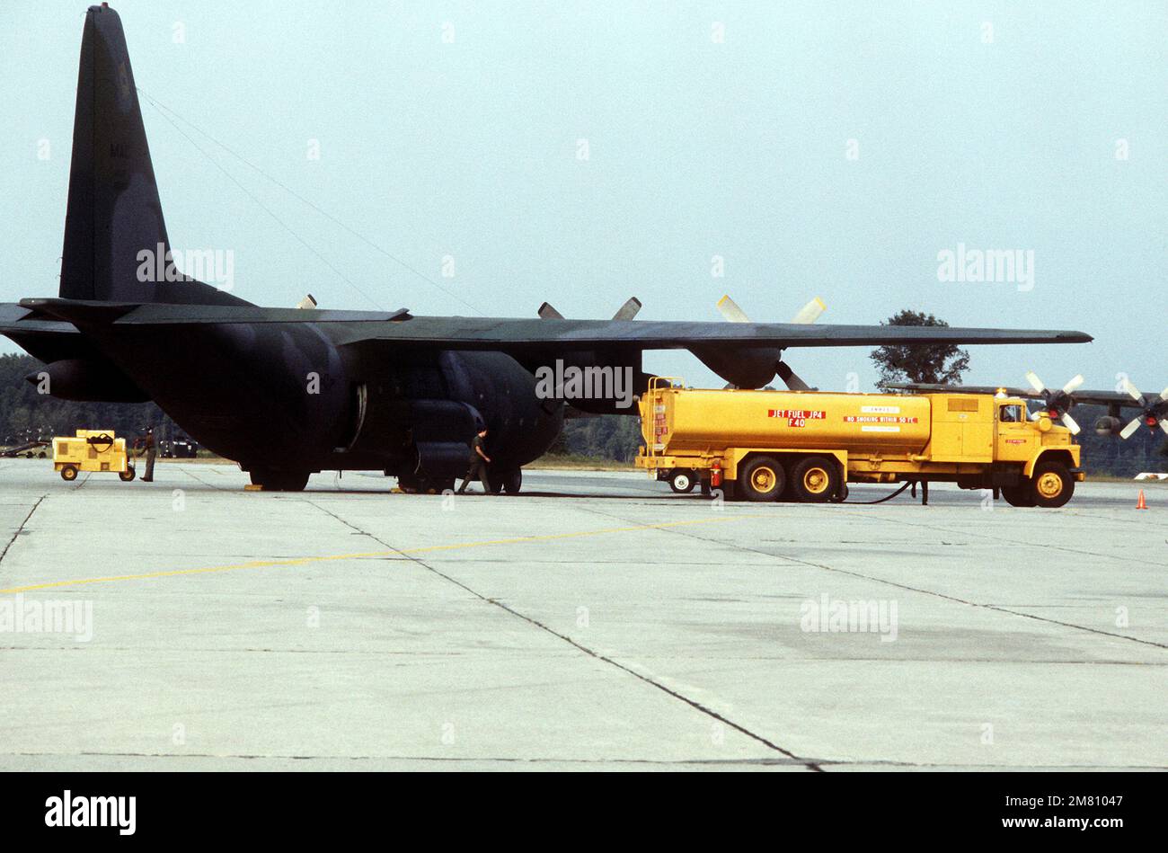 A C-130 Hercules aircraft is refueled on the flight line during the ...