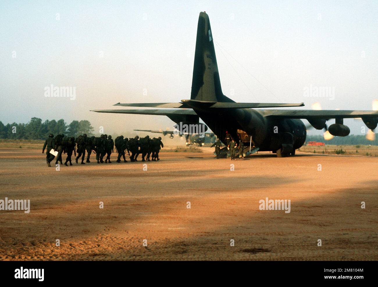 Members of the 101st Airborne Division board a C-130 Hercules aircraft ...