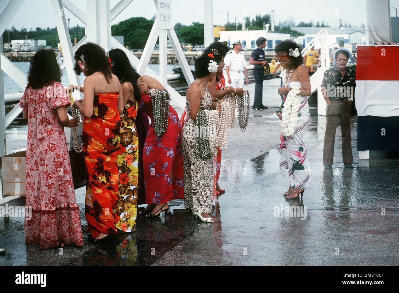 Guamanian women wait at Naval Station Guam to welcome the crew of the ...