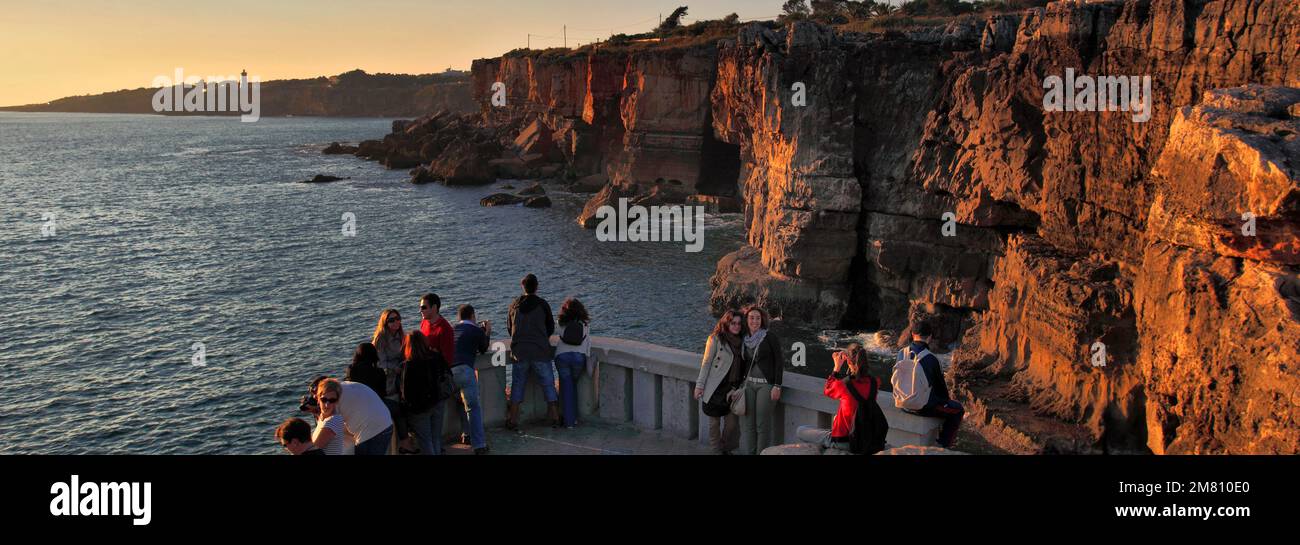 People watching the sunset over the Atlantic Ocean at Boca do Inferno ...
