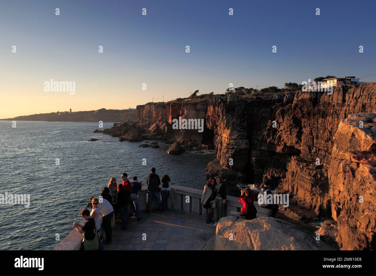 People watching the sunset over the Atlantic Ocean at Boca do Inferno ...