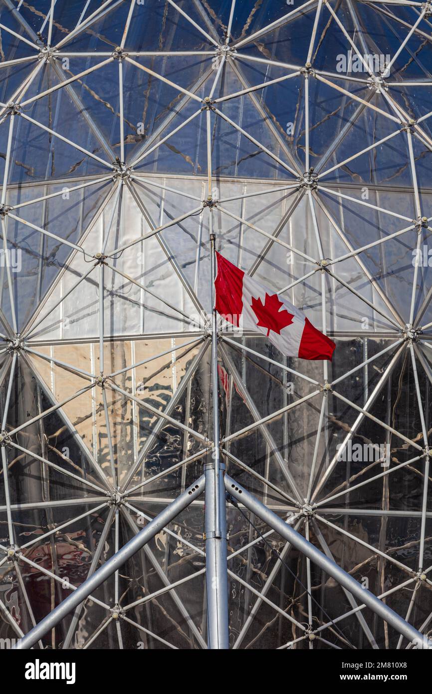 Canadian flag against the geodesic dome of the BC Science Centre in ...