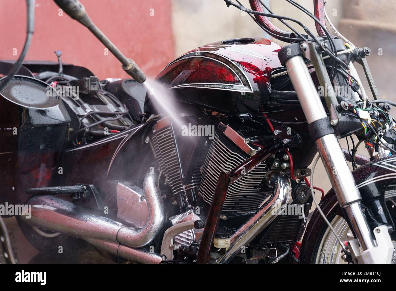 Washing a motorcycle engine with a high pressure jet. Close-up Stock ...