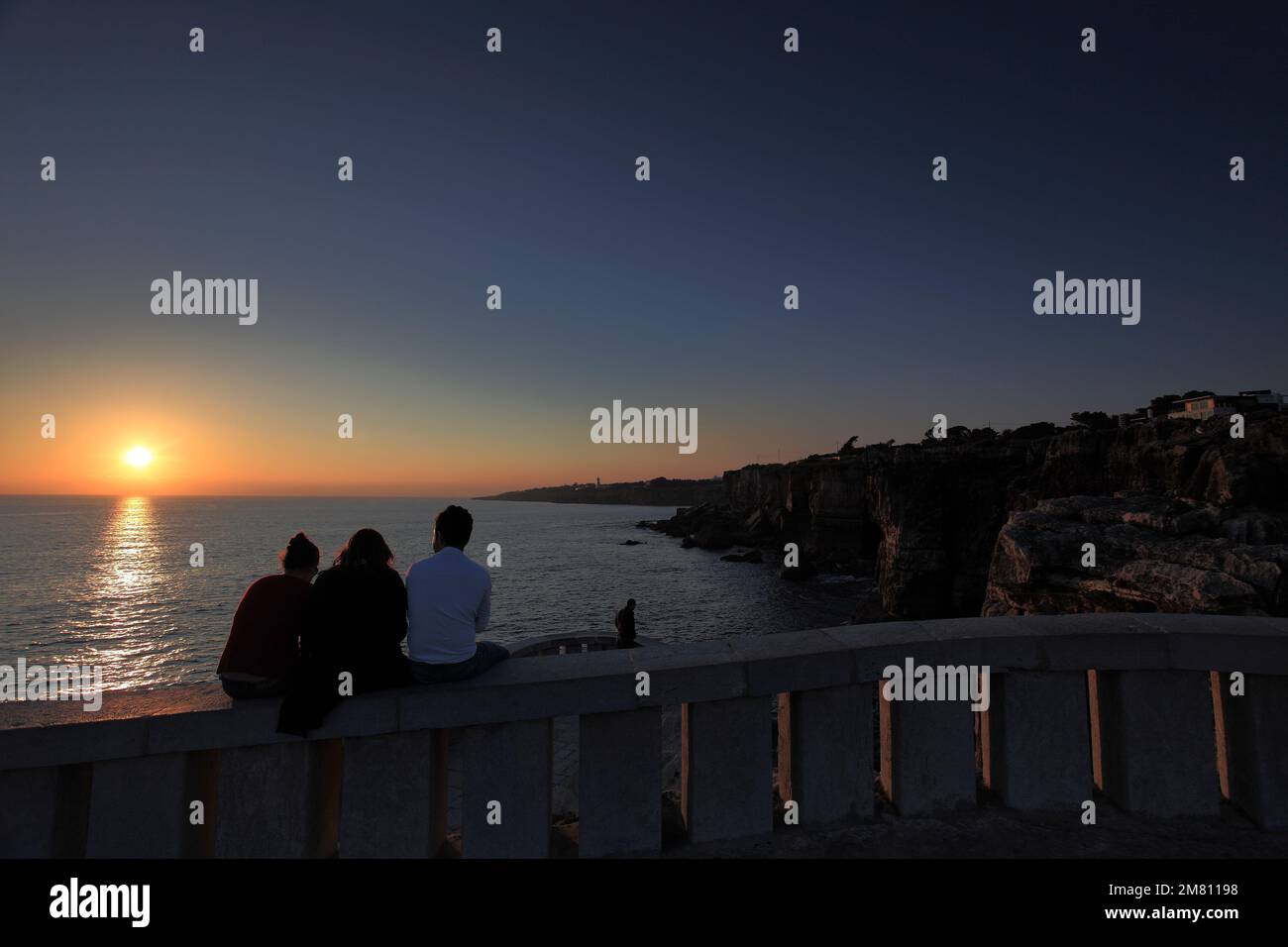 People watching the sunset over the Atlantic Ocean at Boca do Inferno ...