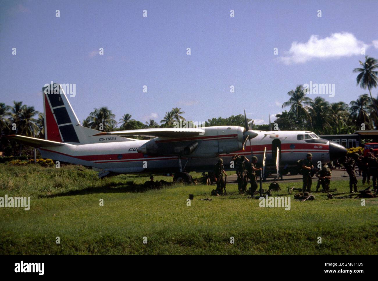 U.S. Marines congregate around a Soviet-made An-26 Curl transport ...
