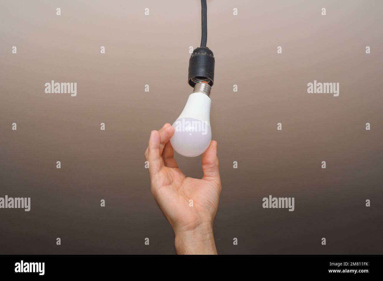 replacement installation electric LED. in the man's hand is an electric ...