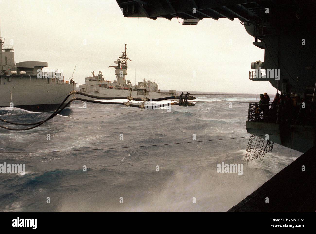 Fuel lines from the Neosho class oiler USNS KAWISHIWI (TAO 146) are ...