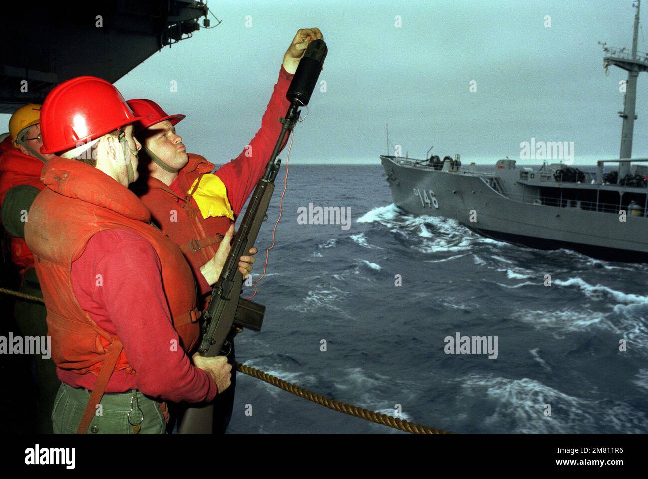 Crewmembers aboard the aircraft carrier USS KITTY HAWK (CV 63) prepare ...