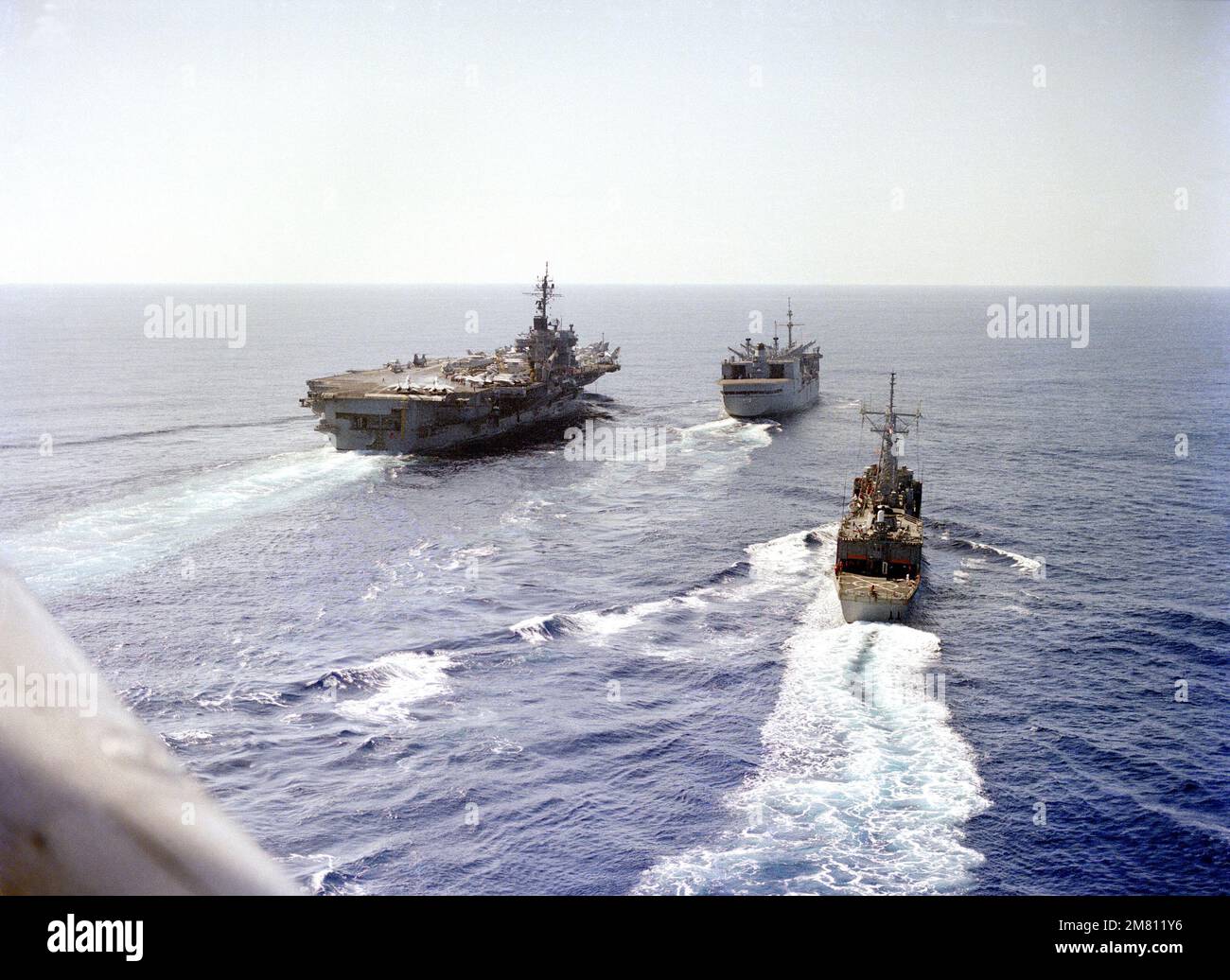 An aerial view, left to right, of the aircraft carrier USS KITTY HAWK ...