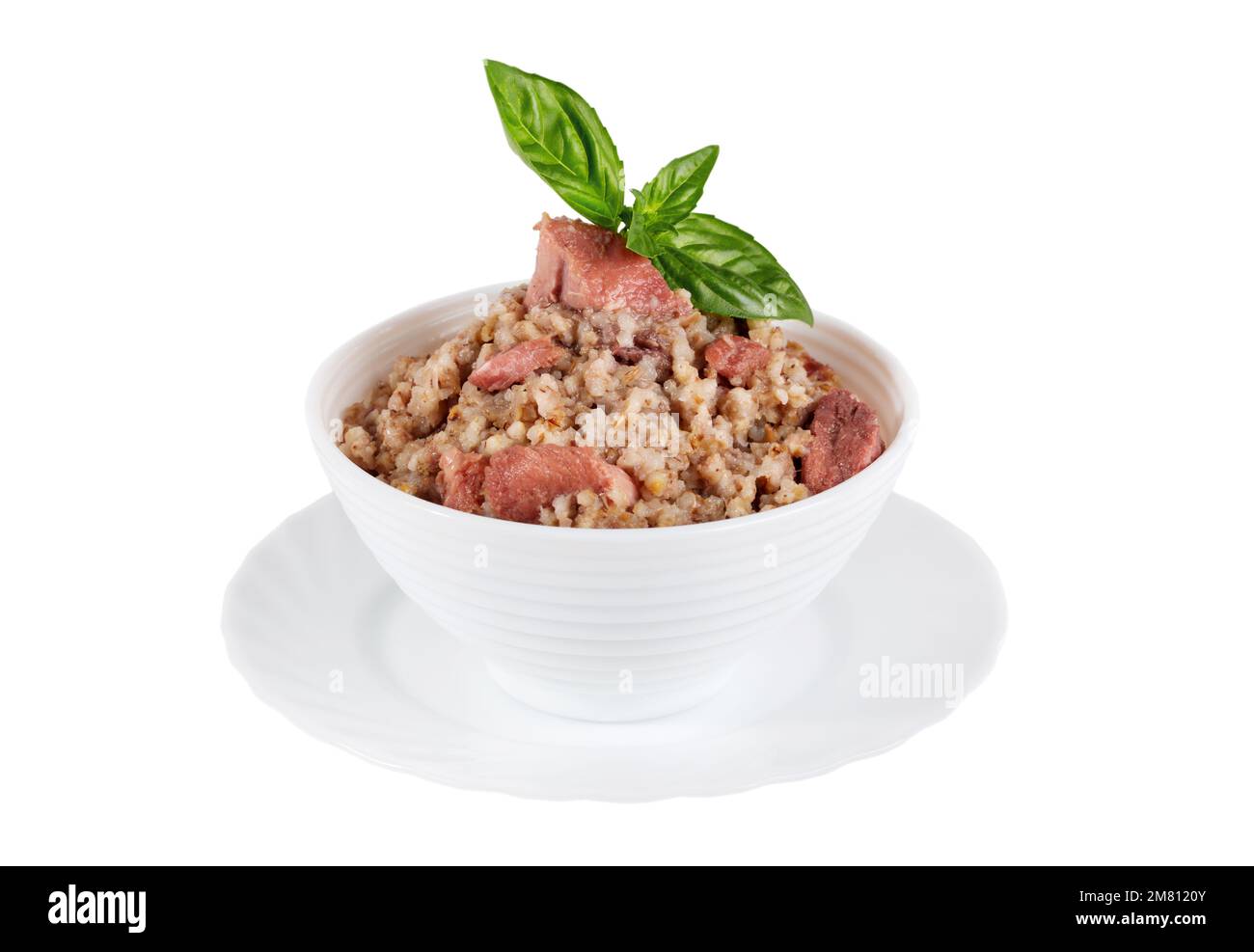 Canned barley porridge with meat and basil in a bowl isolated on white ...