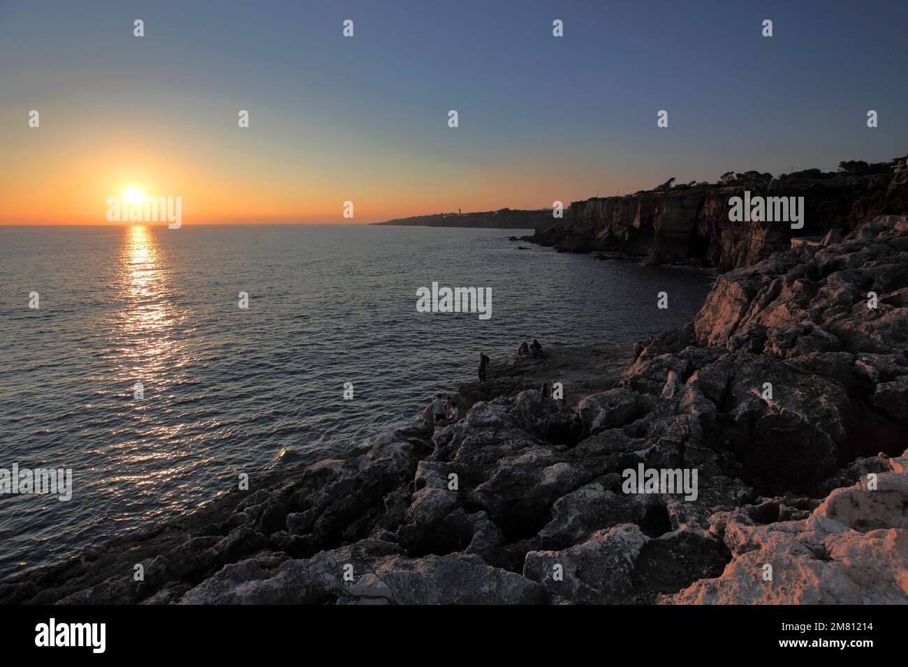 People watching the sunset over the Atlantic Ocean at Boca do Inferno ...