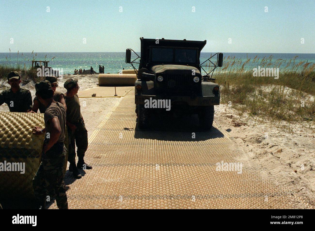 Members of the 497th Engineer Company use MO-MAT roadway system panels ...