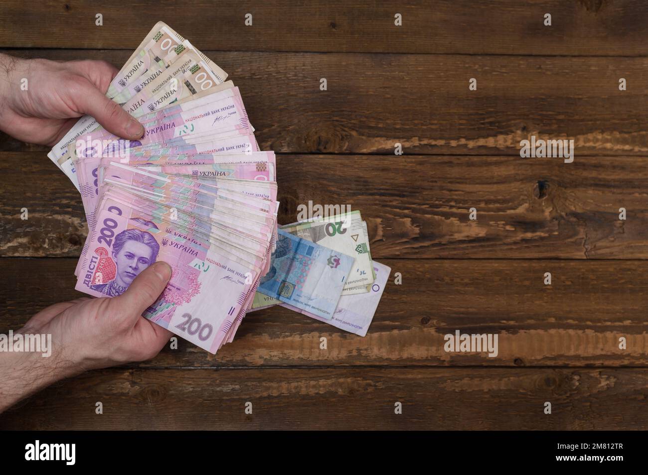 Money fan in men's hands close-up Stock Photo - Alamy