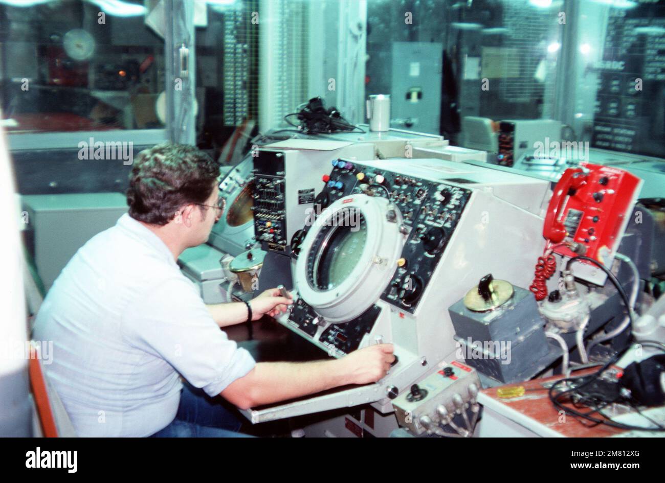 A radar technician operates the SPA-66 radar scope in the combat ...