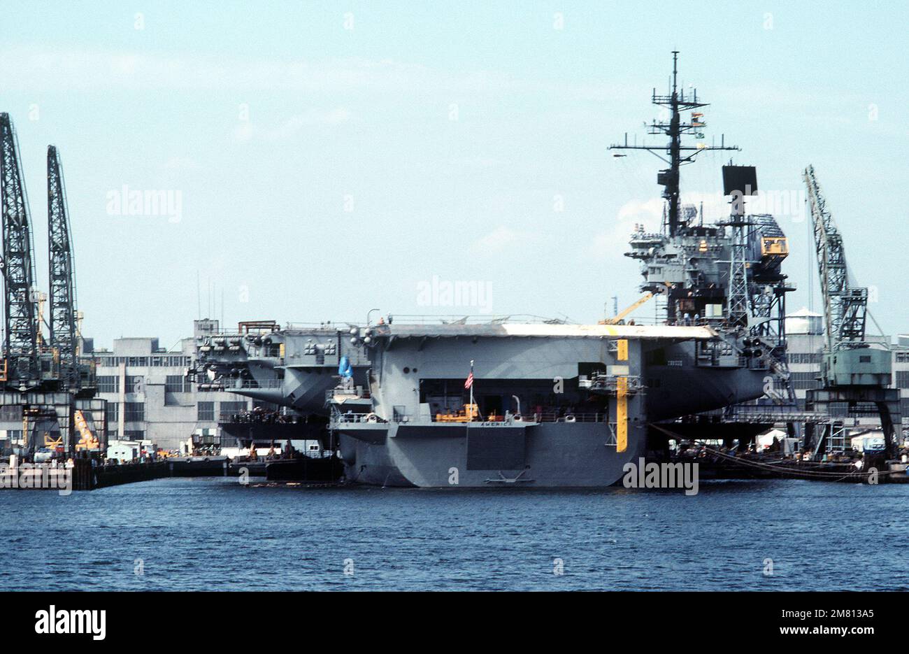 A stern view of the aircraft carrier USS AMERICA (CV 66) undergoing an ...