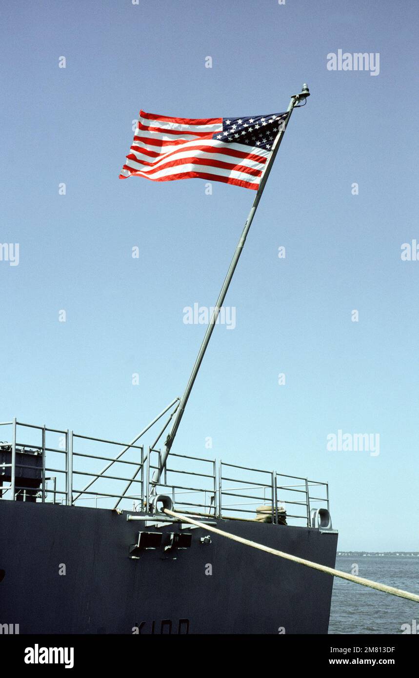 The colors fly from the stern of the guided missile destroyer USS KIDD ...