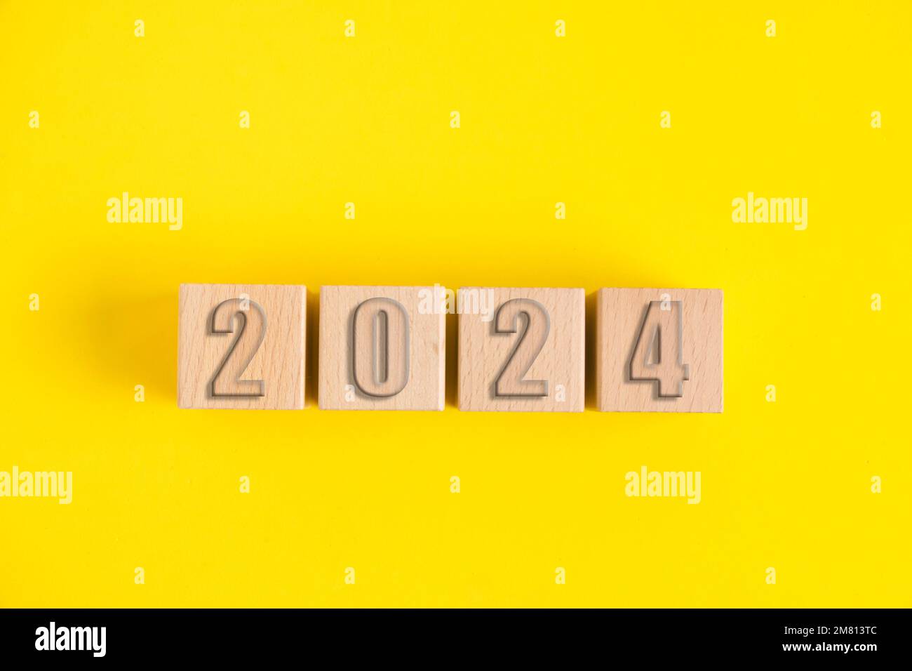 Wooden cubes with numbers 2024 yellow background Stock Photo - Alamy