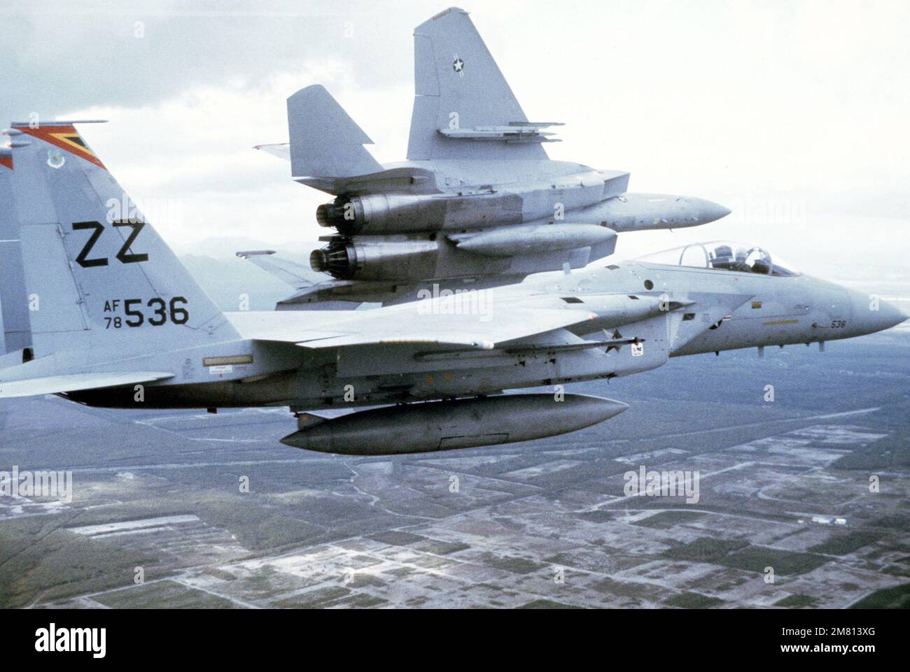 An air-to-air right underside view of an F-15 Eagle aircraft breaking ...