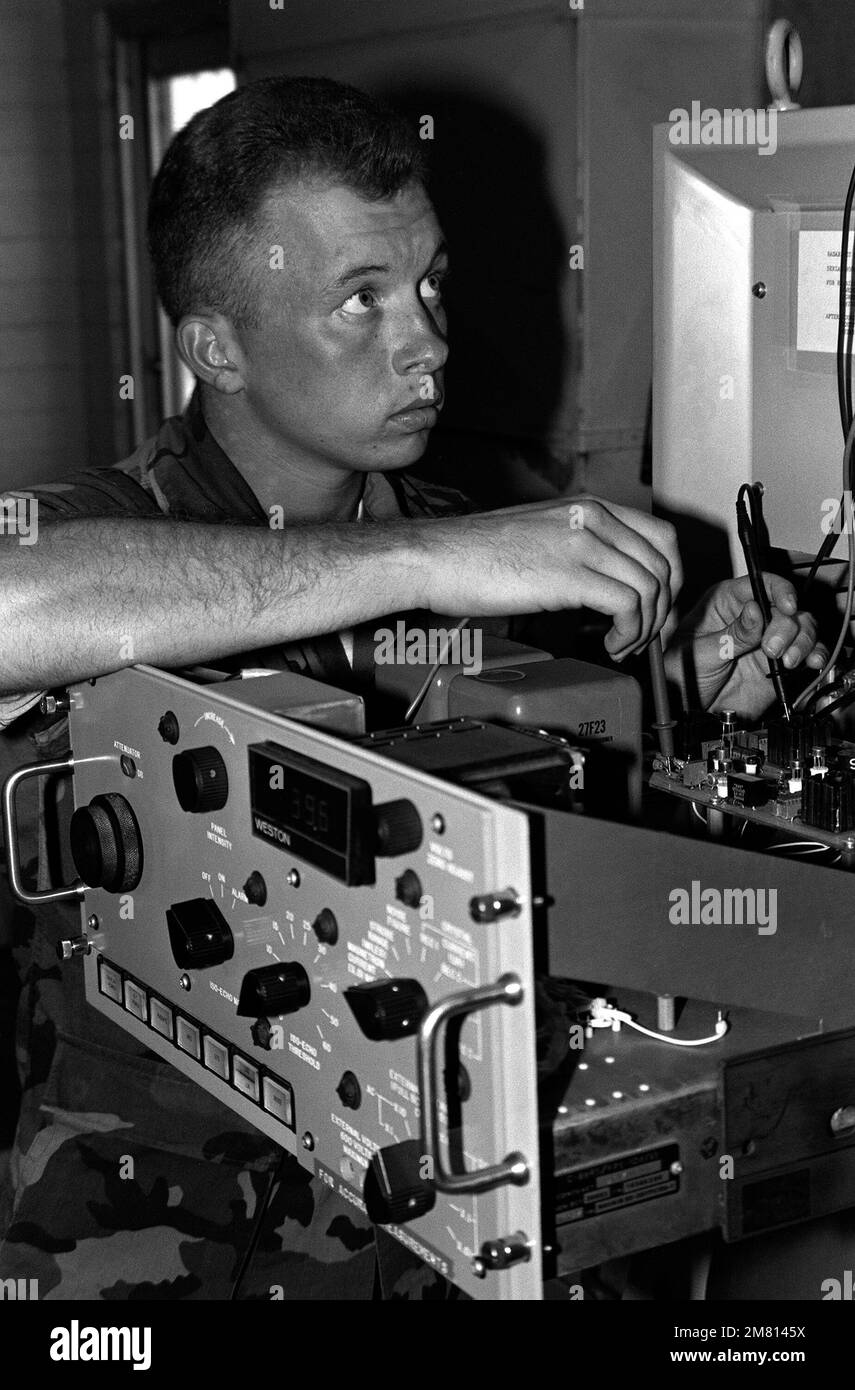 Sergeant Thomas Montgomery repairs a Victor Radar machine. Base: Marine ...