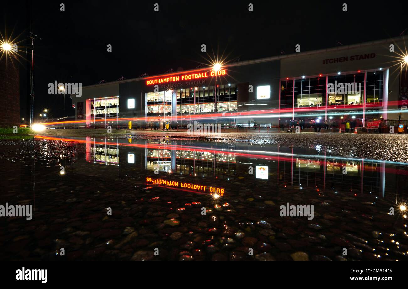 A reflection of the stadium is shown in a rain puddle before the ...
