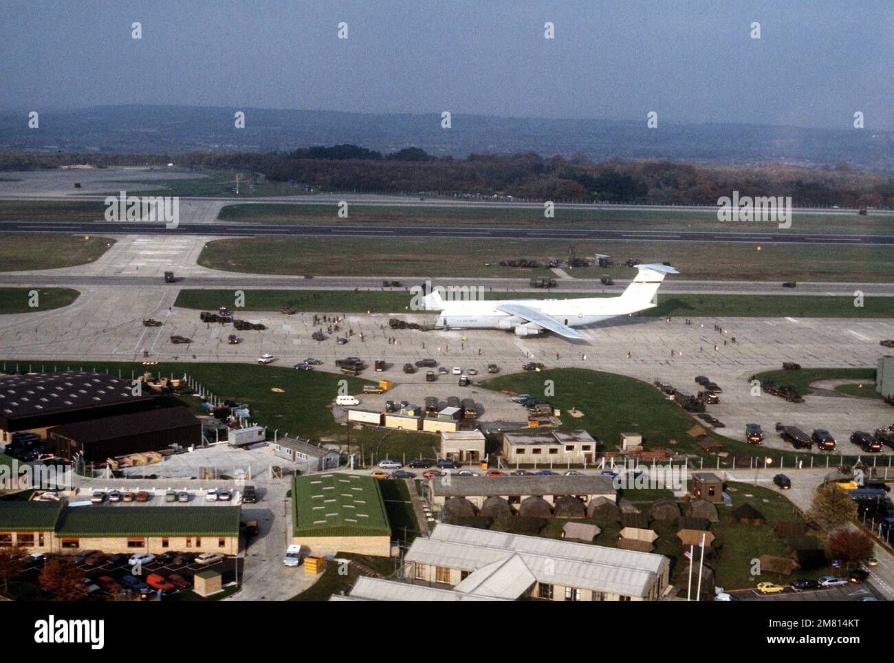 An aerial left side view of a C-5 Galaxy aircraft during the offloading ...
