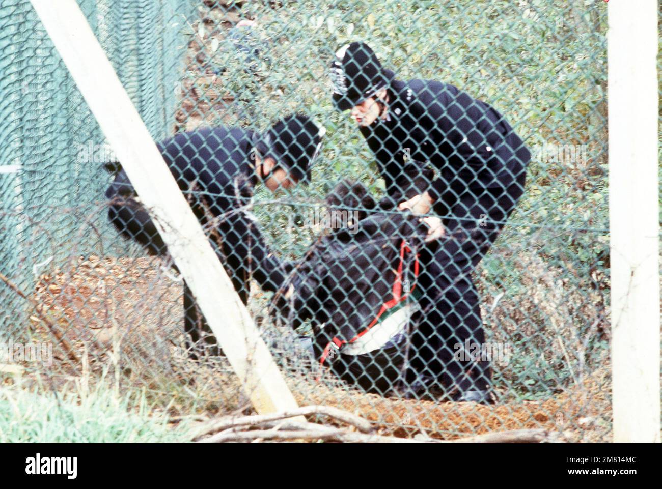 Two British police officers confront an anti-nuclear demonstrator ...