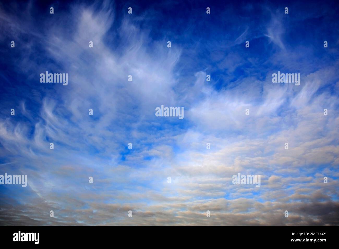 Cirrus Uncinus clouds in a blue sky Stock Photo - Alamy