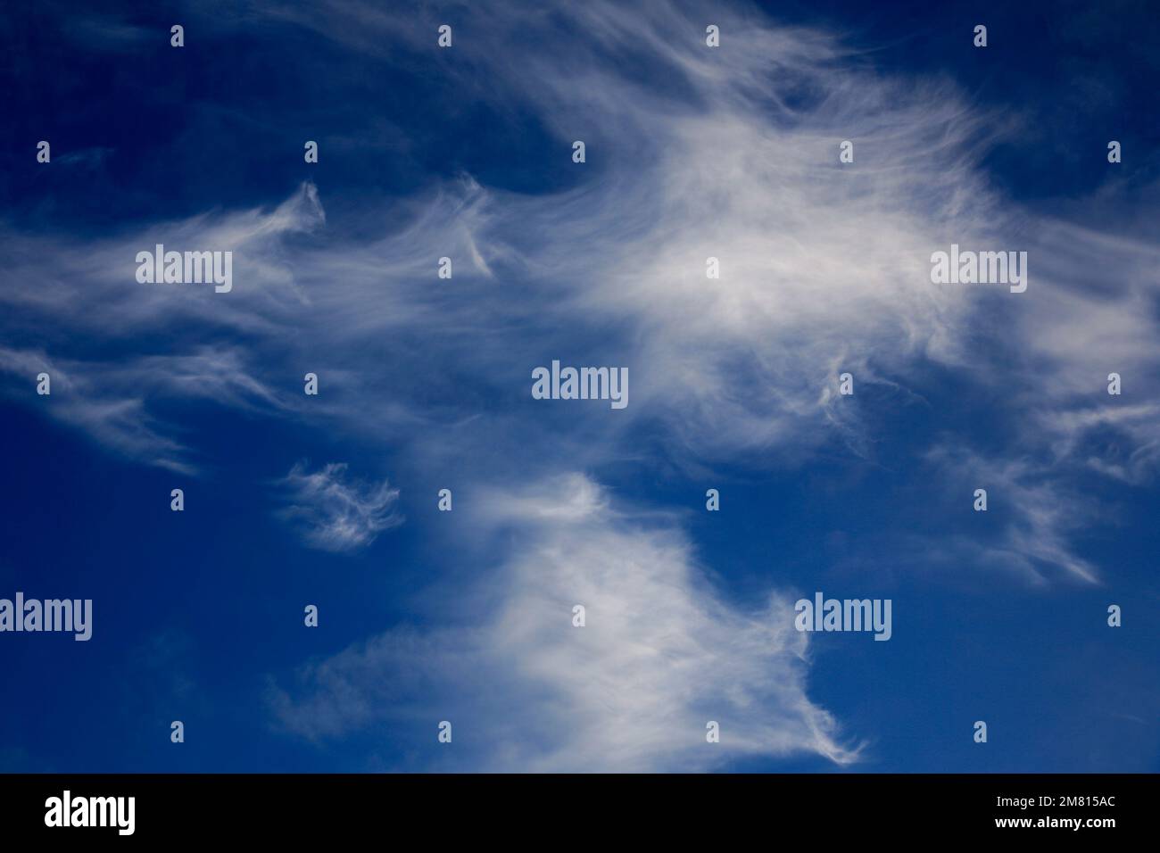 Cirrus Uncinus clouds in a blue sky Stock Photo - Alamy