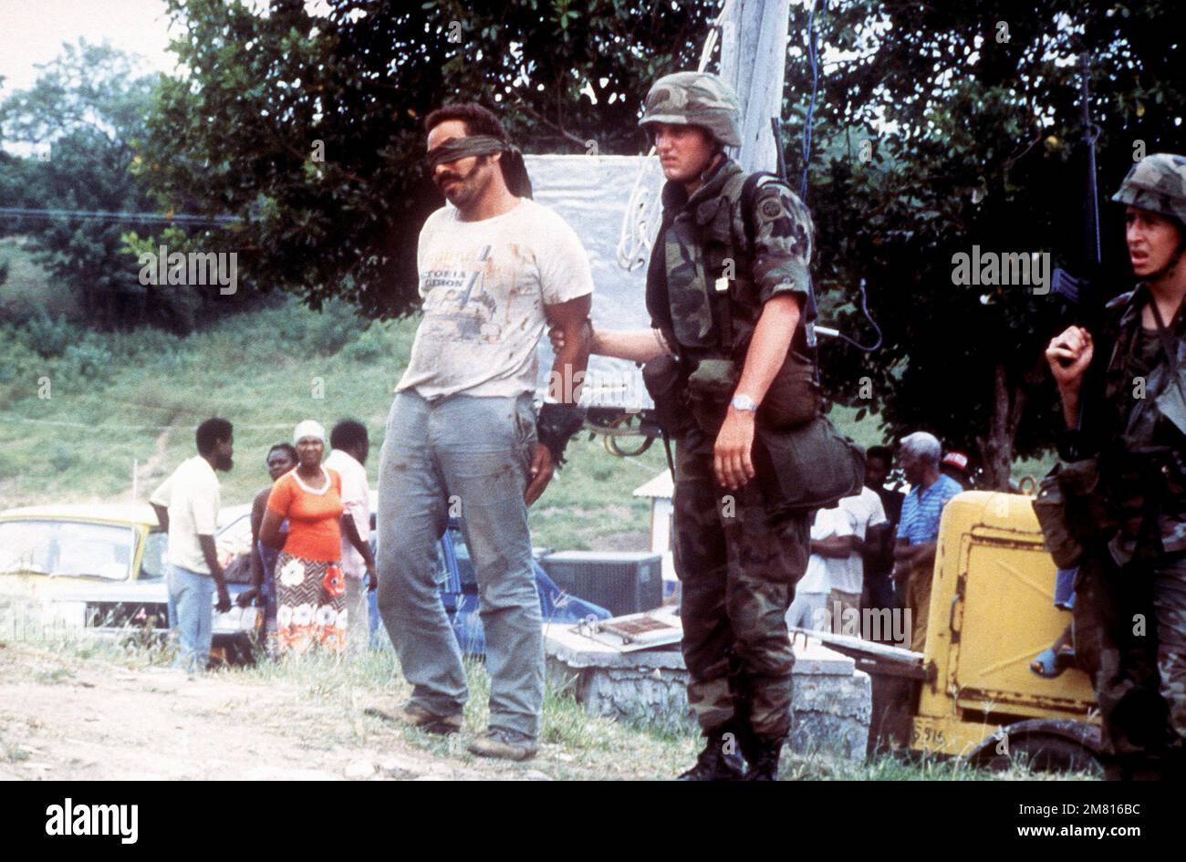 Members of the 82nd Airborne Division guard a blindfolded prisoner ...
