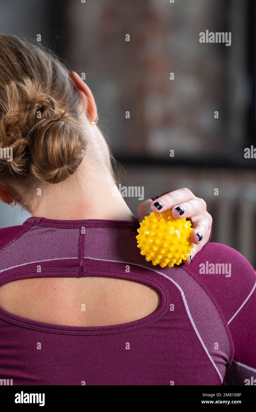 The athlete does a relaxing massage of the neck and back with the help ...