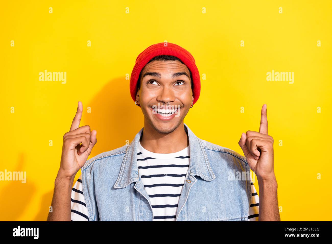 Photo of positive cool guy wear trendy clothes two arm presenting empty ...