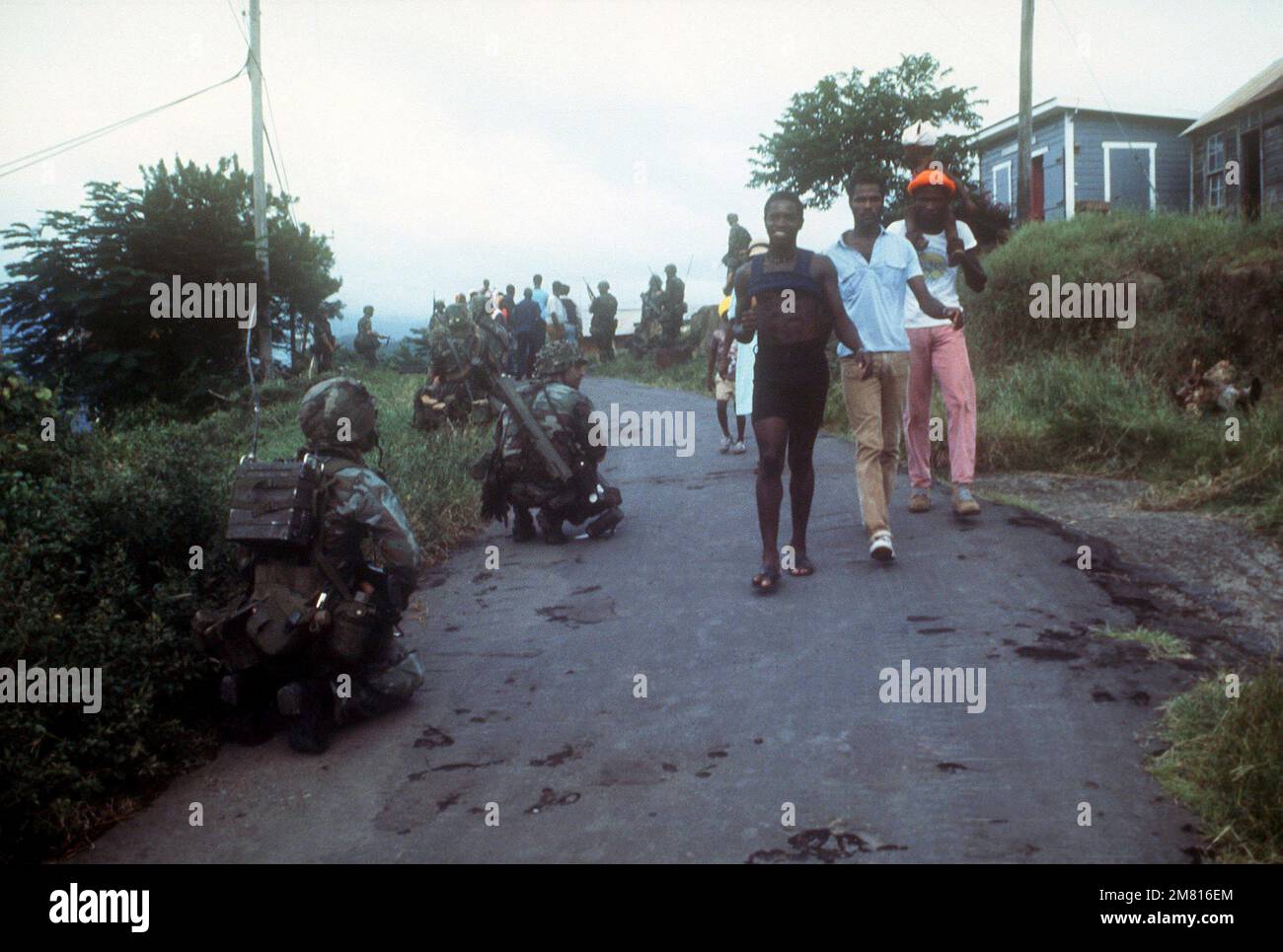 Members of the 82nd Airborne Division encounter a group of Grenadians while on patrol during ...