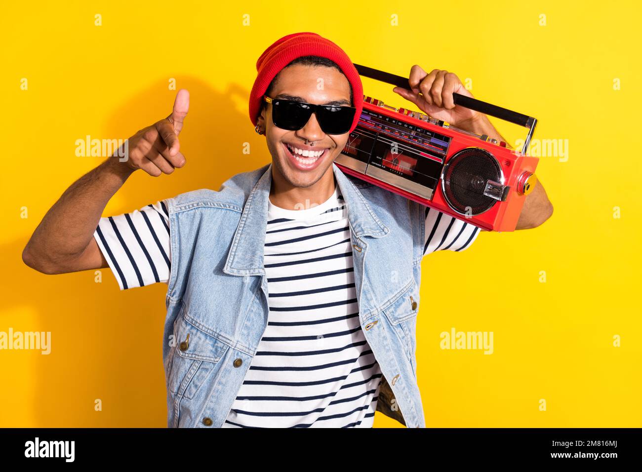 Photo of funny cheerful man carry boombox point finger camera you ...