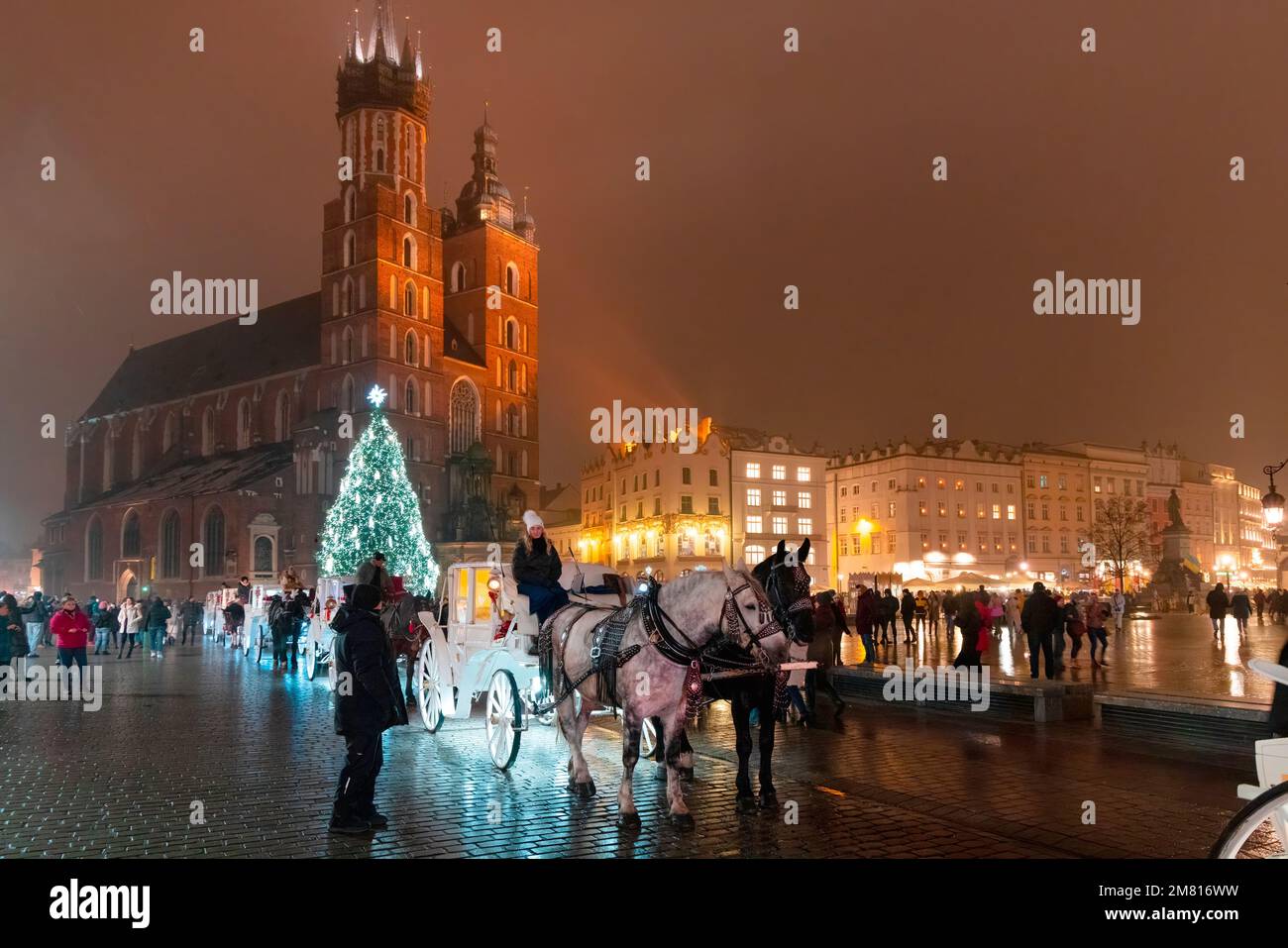 Krakow tourism; Main Market Square at night, with St Marys Church lit ...