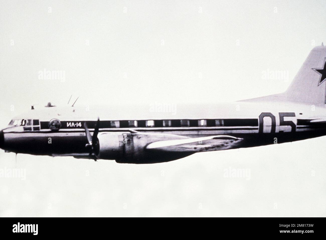 An air-to-air left side view of a Soviet IL-14 Crate transport aircraft ...