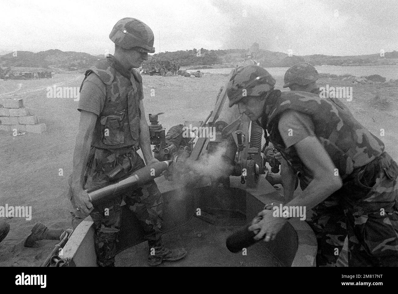 82nd Airborne Division artillerymen reload an M102 105 mm howitzer ...