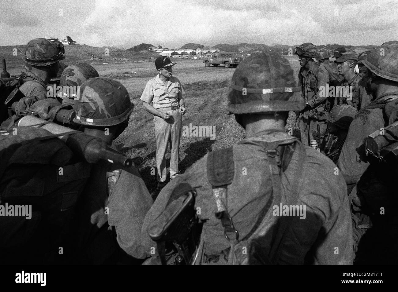 Vice Admiral Joseph Metcalf, Commander of Task Force 120, speaks to a ...