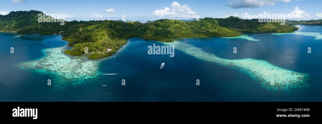 Extensive coral reefs fringe rainforest-covered islands in the Solomon ...