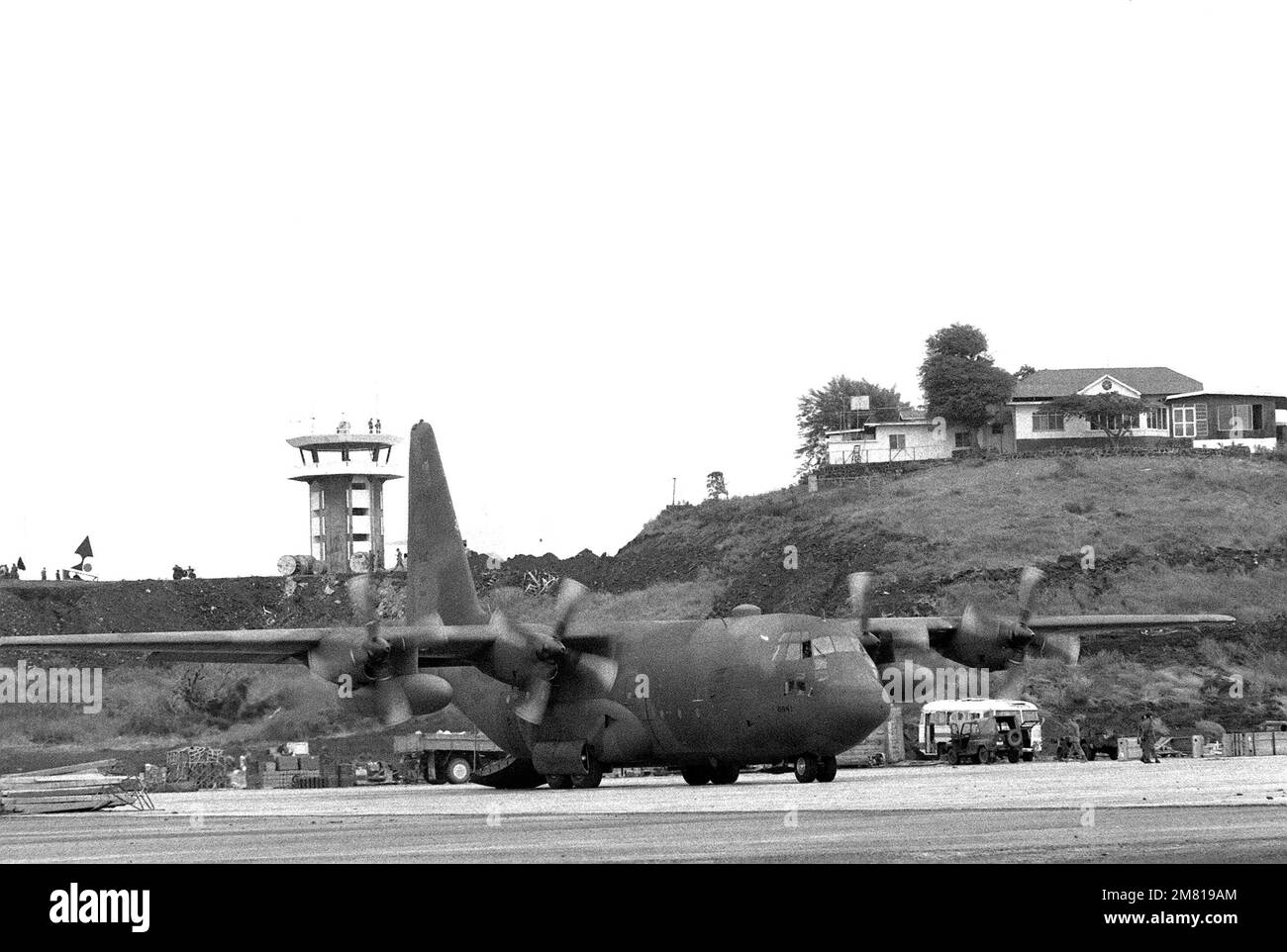 A C-130 Hercules aircraft on the flight line at Point Salines Airfield ...