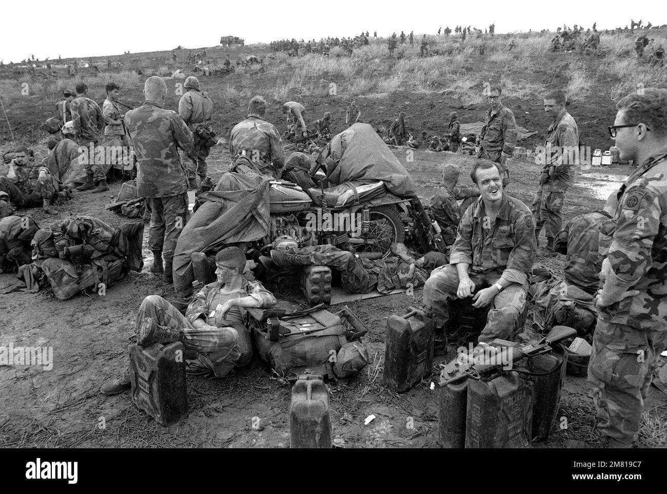 Members of the 82nd Airborne Division relax on a ridge behind the Point ...