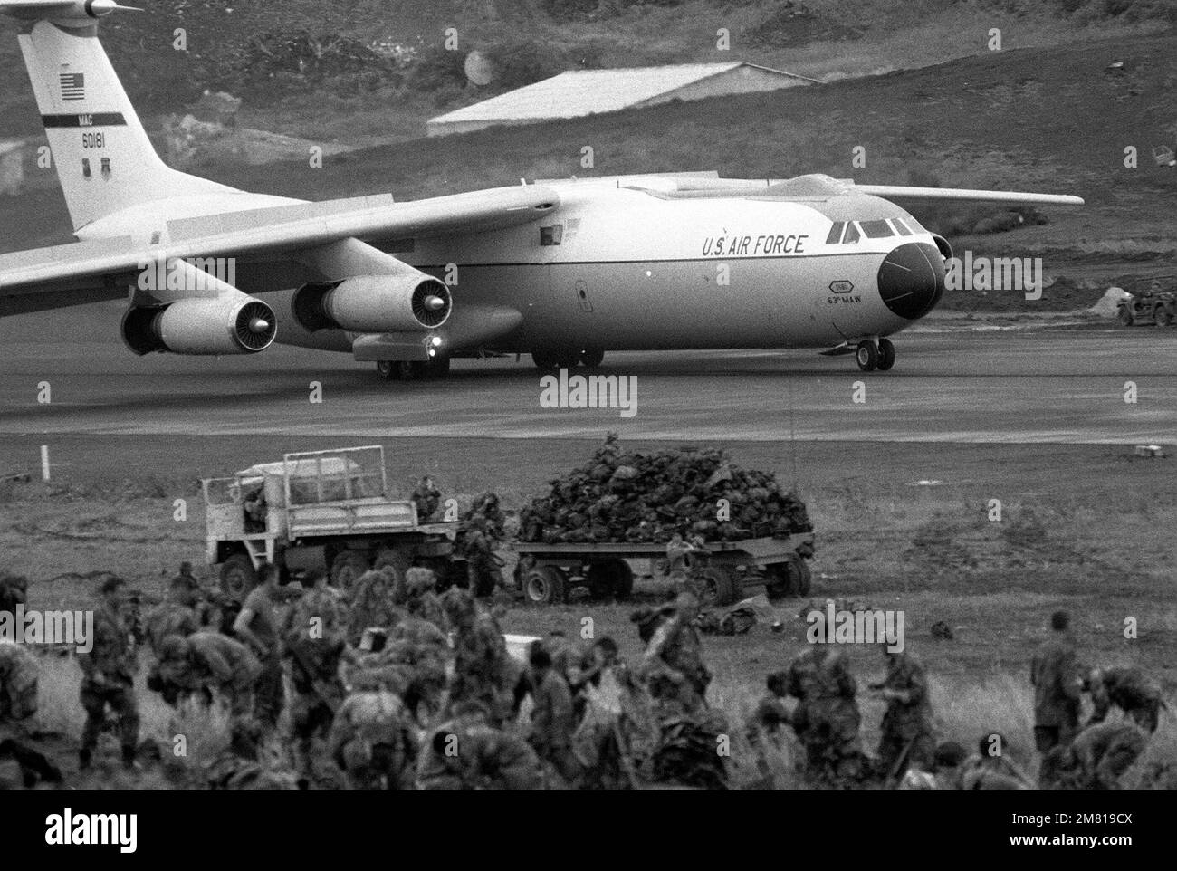 Members of the 82nd Airborne Division gather their gear and prepare to ...