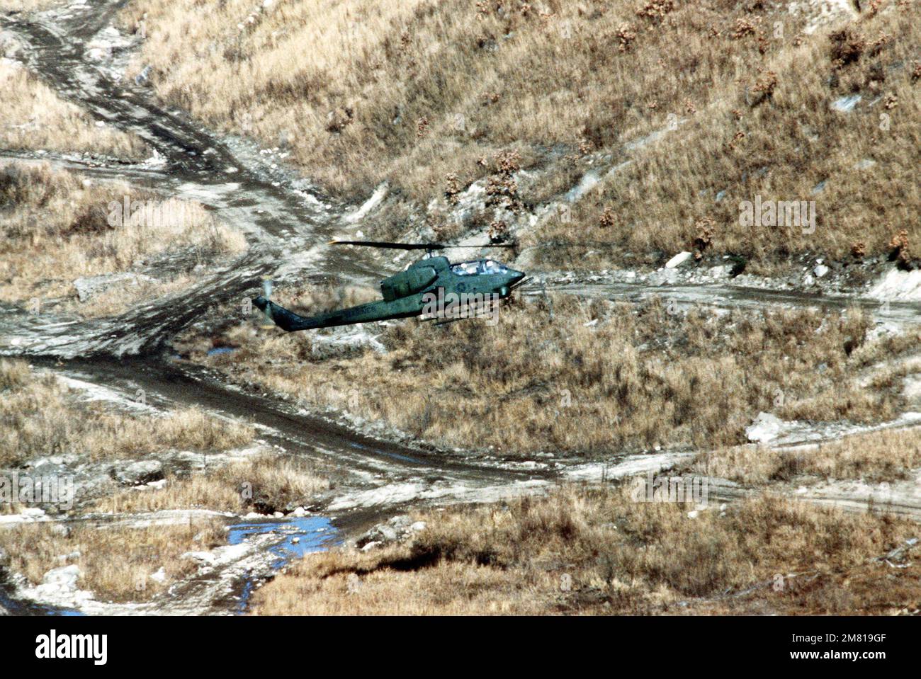 An AH-1J SeaCobra helicopter provides close air support for a live-fire ...
