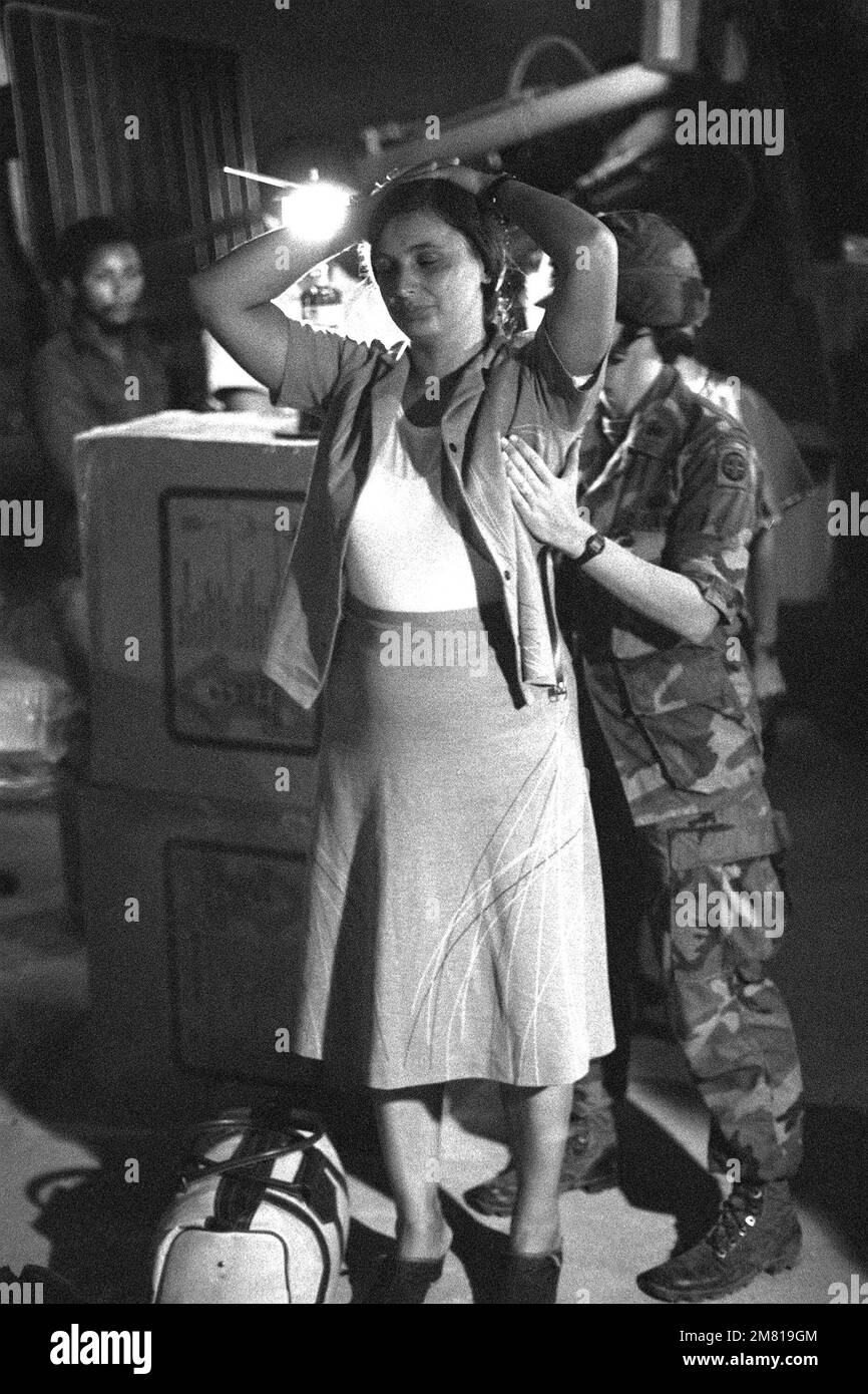 A member of the 82nd Airborne Division searches a Cuban national at the ...