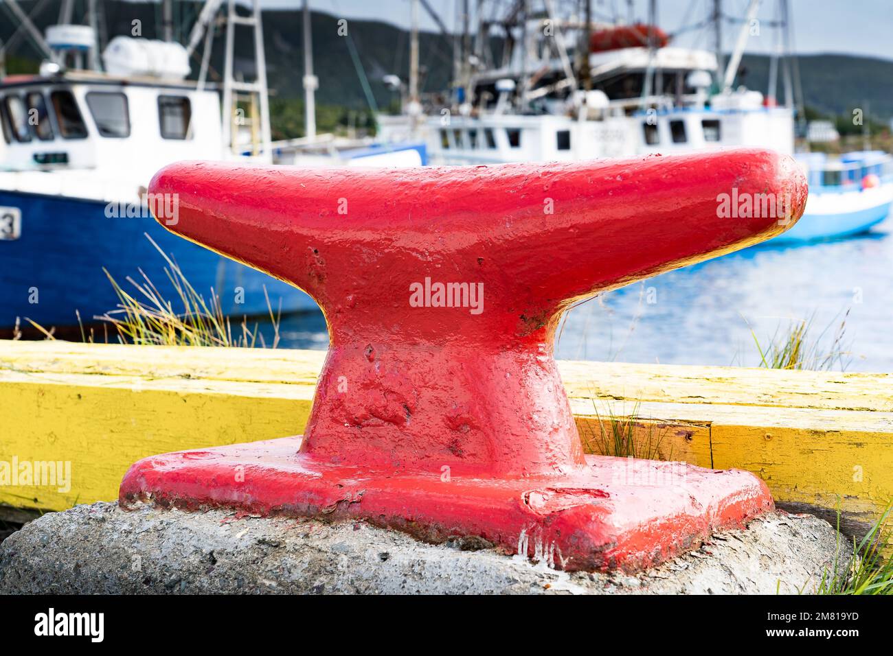 Large boat cleat used for securing fishing vessels at a seaside port in ...