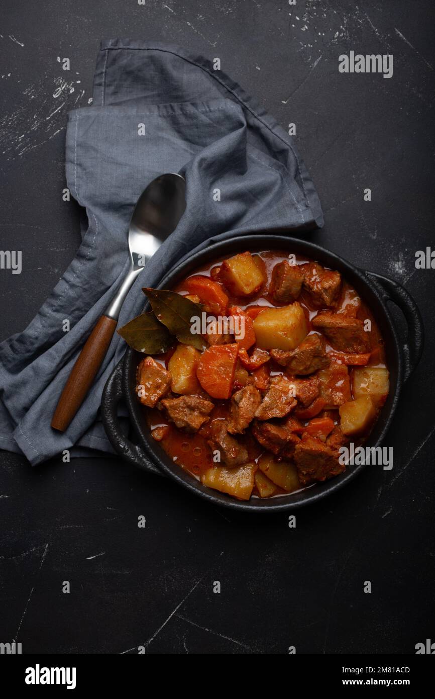Beef meat stew with potatoes, carrot and delicious gravy in black ...