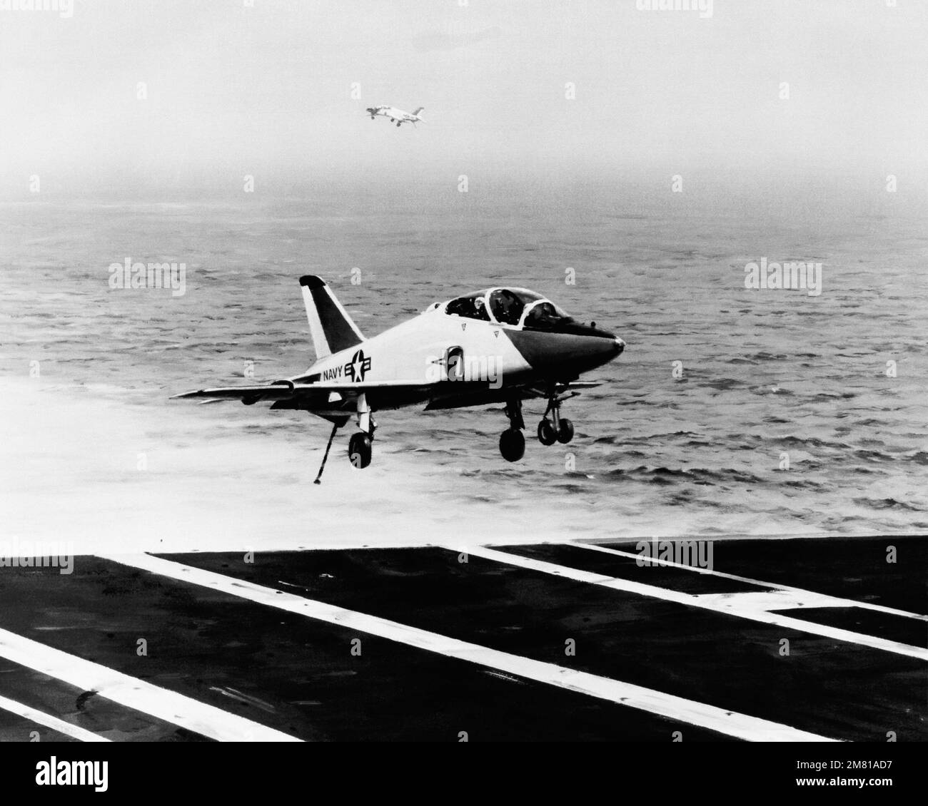 An artist's concept of a T-45A Hawk aircraft landing on the flight deck ...